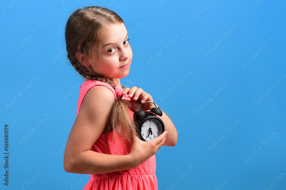 School girl with interested face isolated on blue background Stock ...