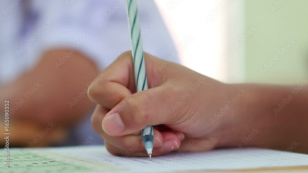 Asian Students holding pencil in hand doing multiple-choice quizzes or ...