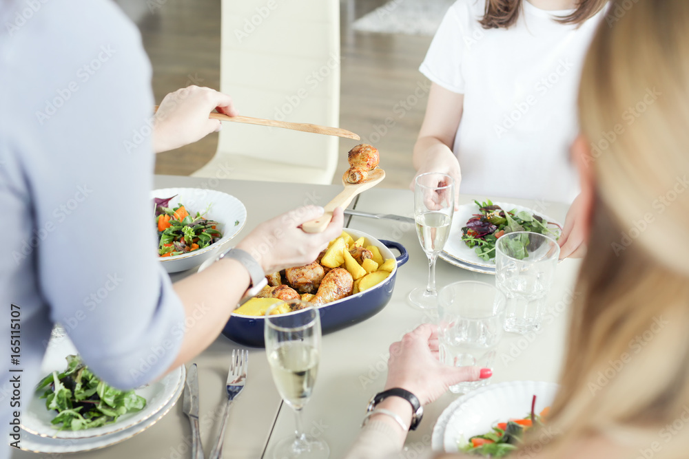 Dinner with friends at home. Group of young women having dinner with ...