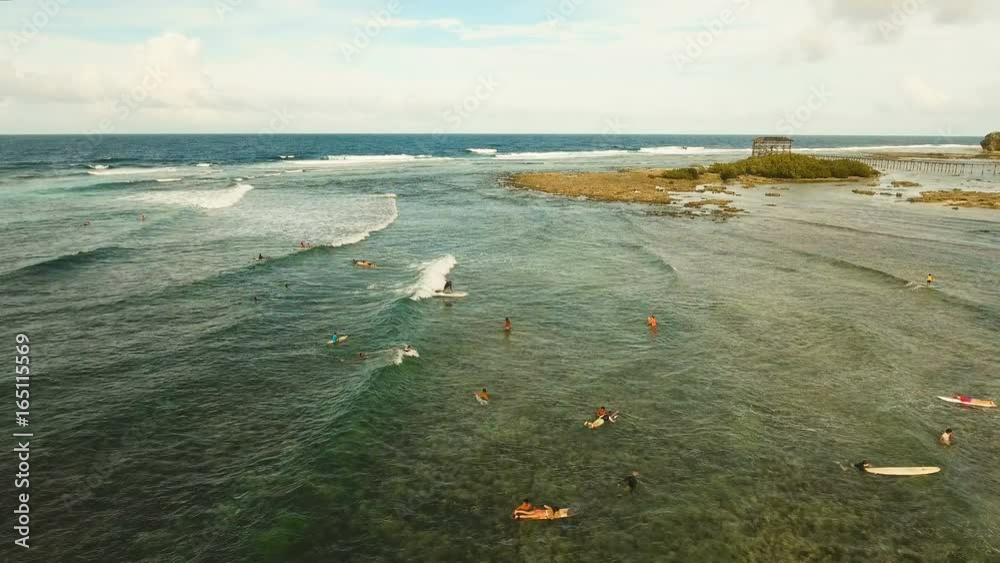 Surfers at siargao islands famous surf break cloud 9 near mindanao the ...