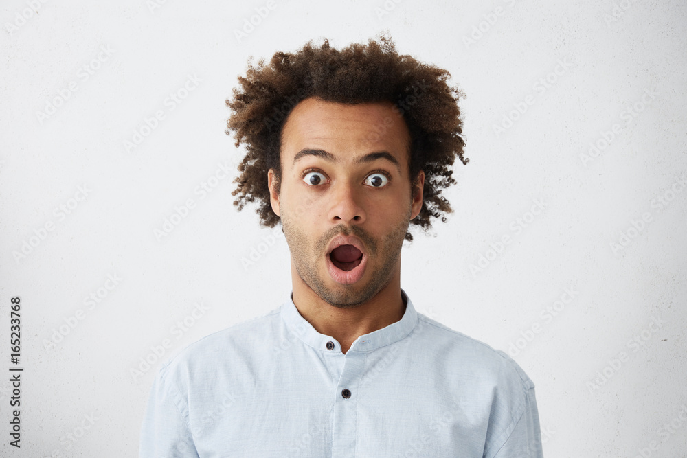 Shock and surprise. Studio portrait of surprised forgetful young man ...