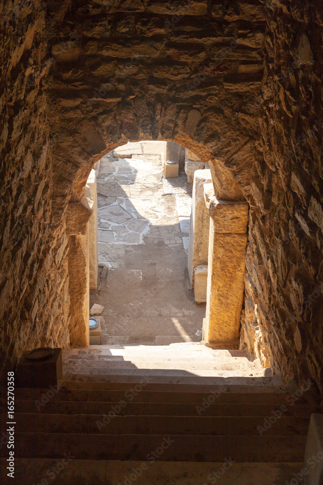 Dark entrance to house ruins with stone arc and columns in ephesus ...