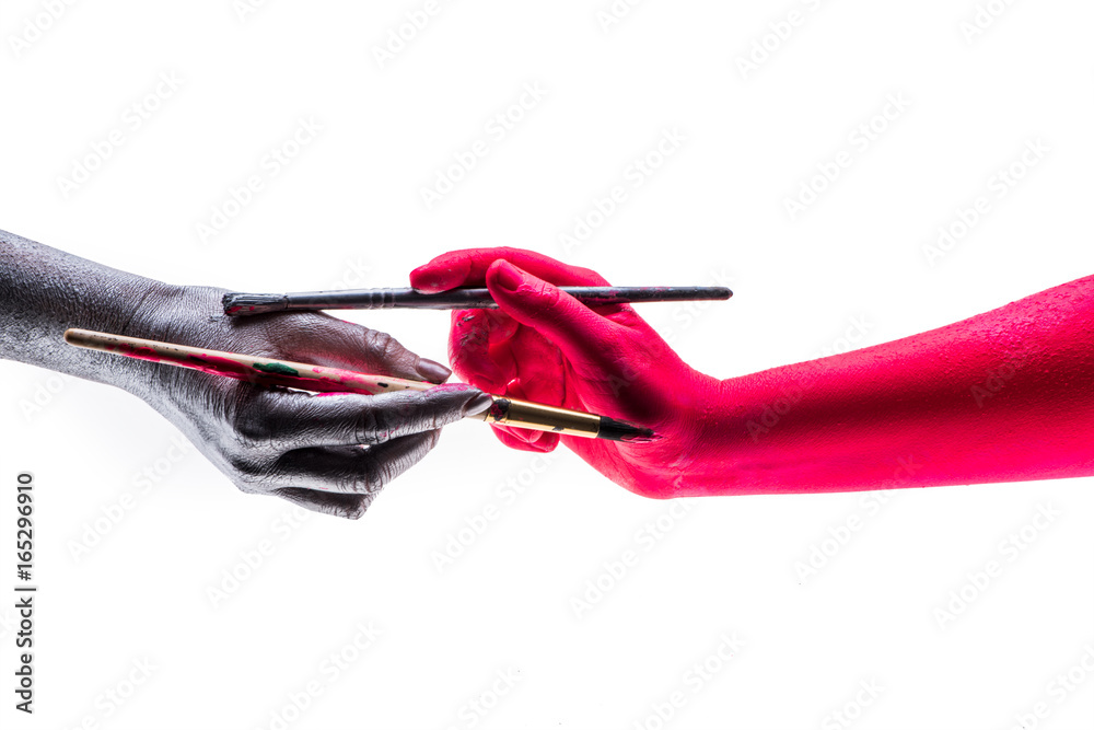 Collaboration creative teamwork. Two colored hands are painted with ...