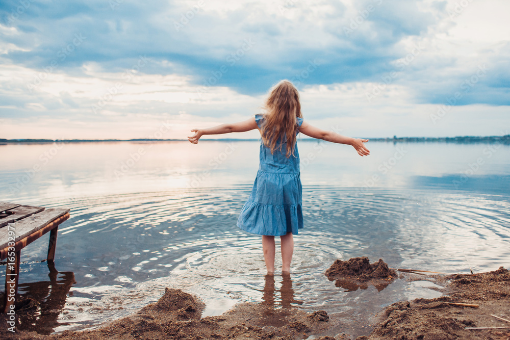 Cute little girl having fun on the lake. Stock Photo | Adobe Stock