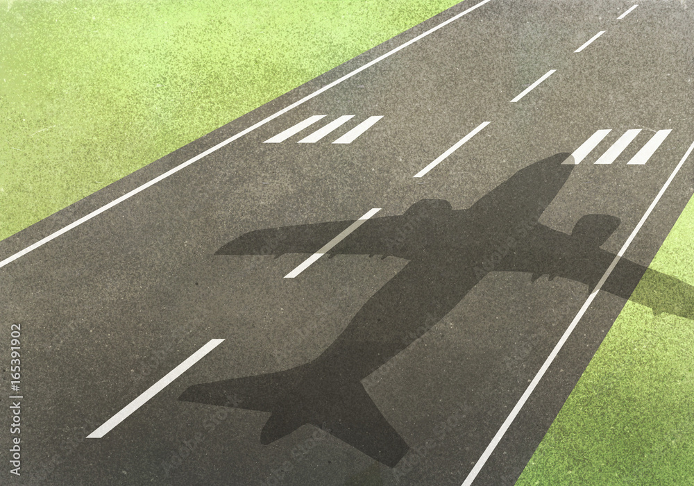 Shadow of airplane on runway amidst field Stock Photo | Adobe Stock