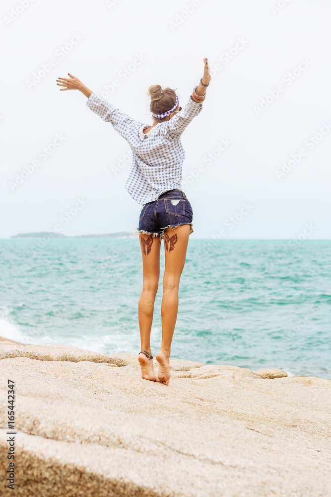 Beautiful fit lady in shirt, jeans shorts and fashion sunglasses dance ...