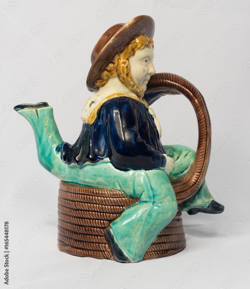 a vintage handmade funny antique teapot, sculpted into a three legged ...