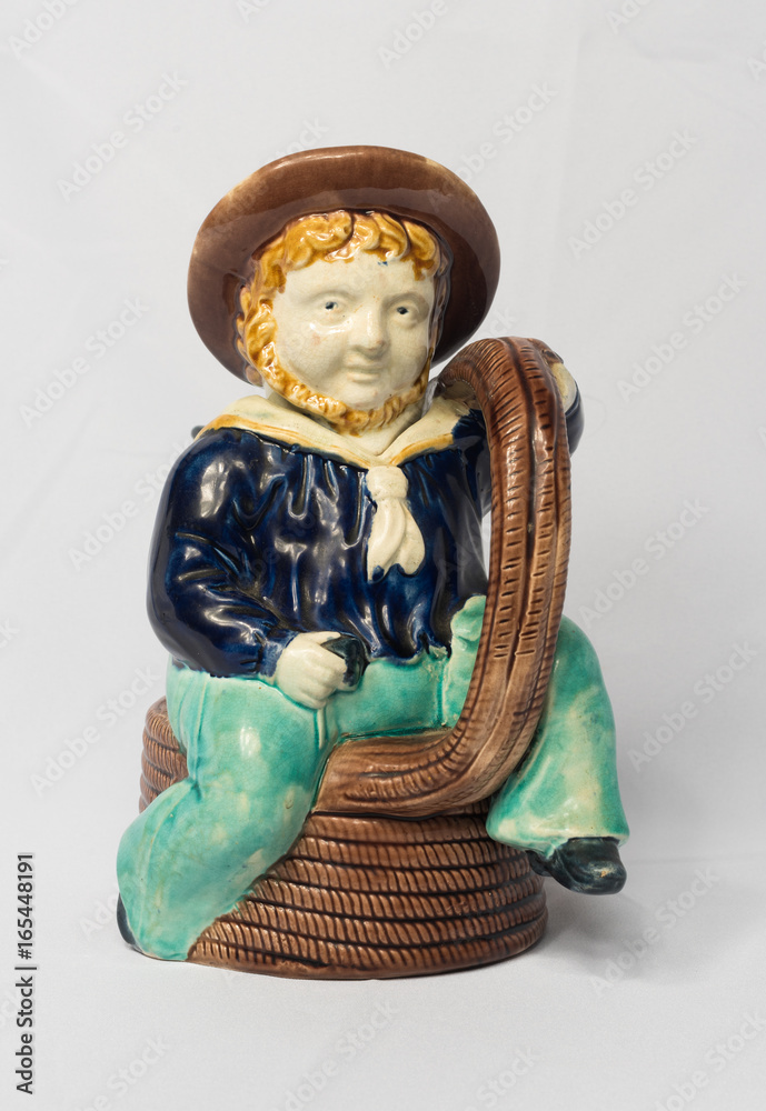 a vintage handmade funny antique teapot, sculpted into a three legged ...