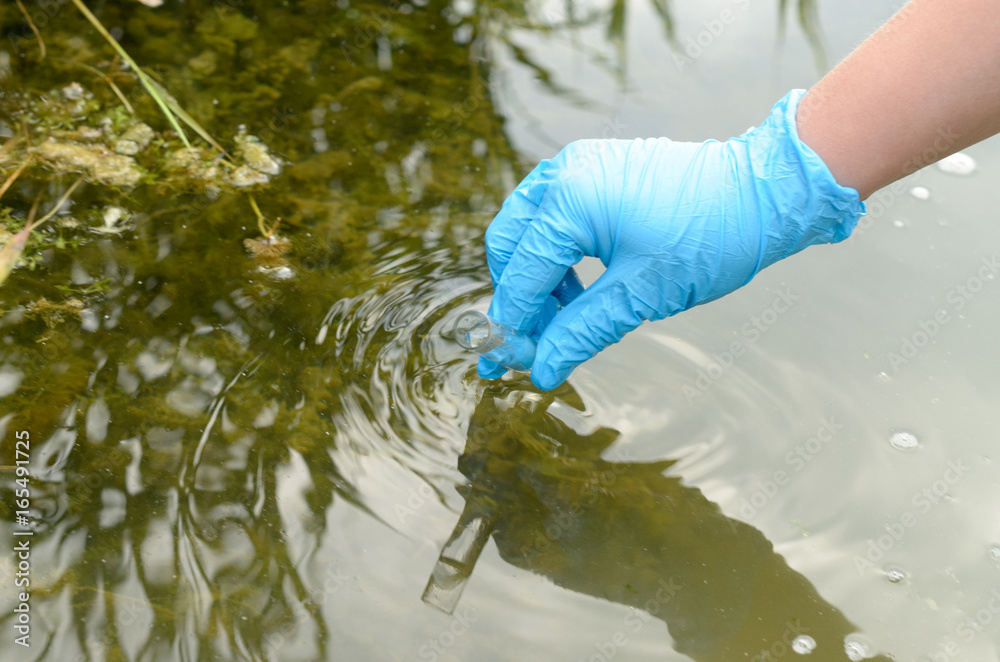 Taking a water test for analysis from a reservoir. Stock Photo | Adobe ...