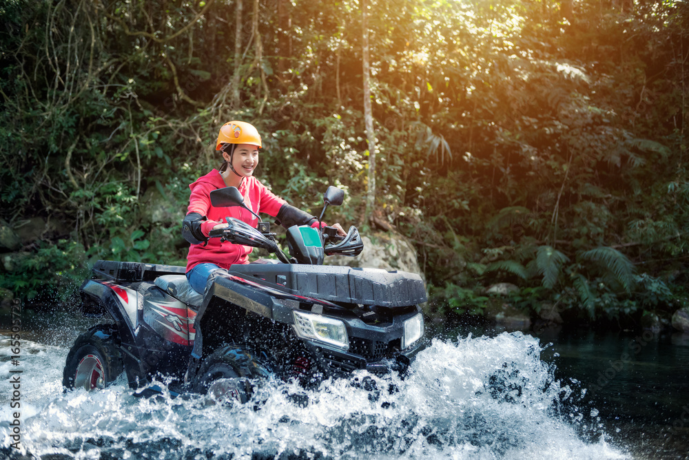 Women are driving an atv adventure in the wild in Asia. Stock Photo ...