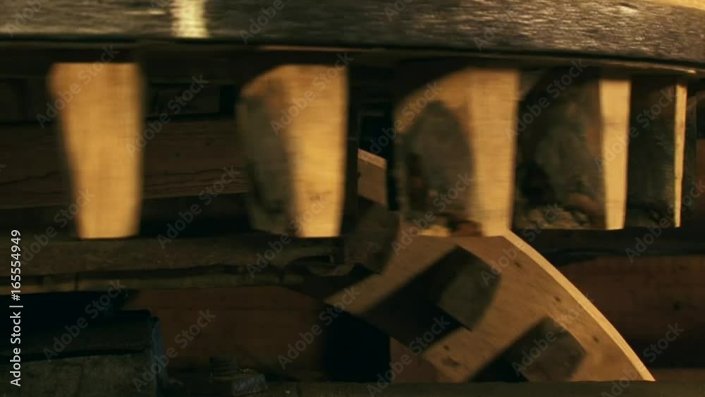 Cogwheels rotate in a 90-degree angle in an industrial corn mill ...