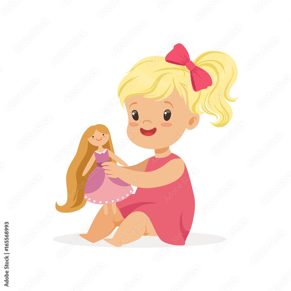 Sweet little girl in a pink dress playing with her doll, colorful ...
