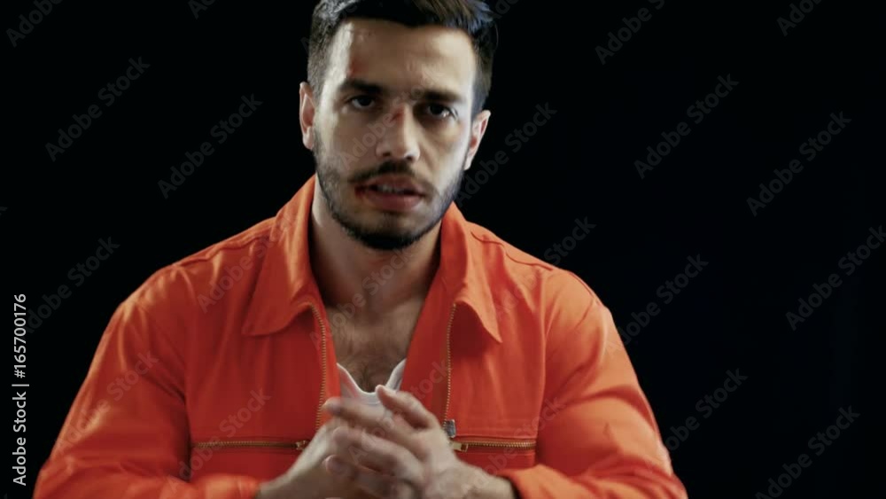 Aggressive Man with a Heavily Bruised Face Makes Threatening Gestures ...