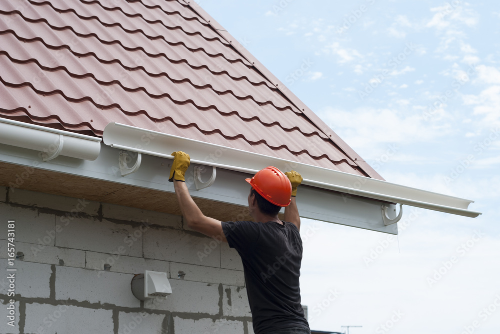 Installation of gutter system Stock Photo | Adobe Stock