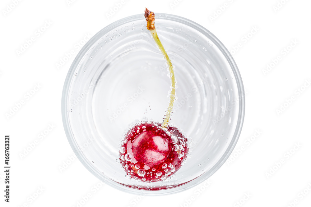 Top view of sweet shiny cherry in soda water with bubbles of carbon ...