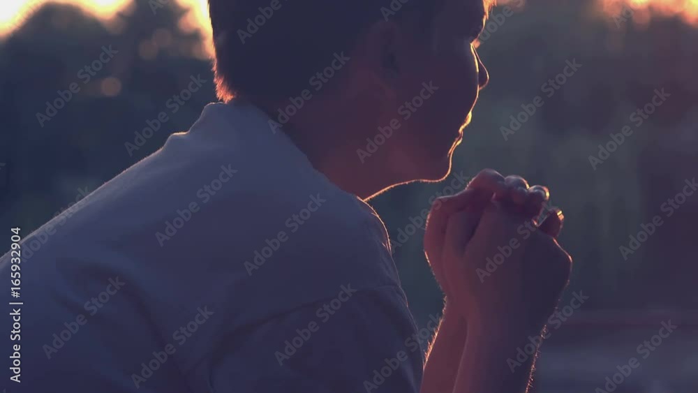 Sad and depressed adult caucasian woman crying on park bench in sunset ...
