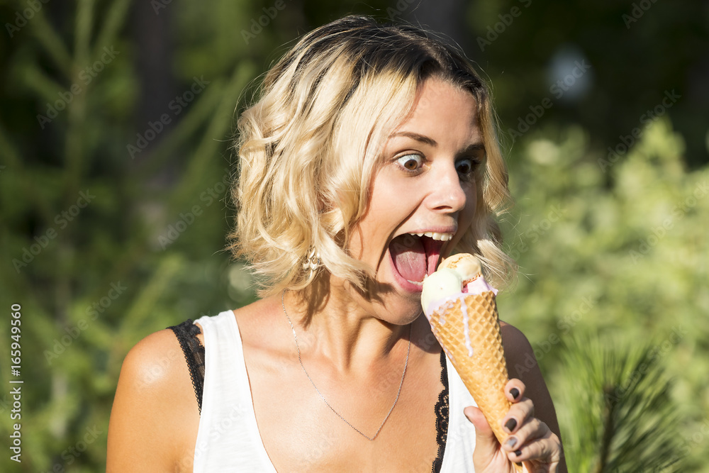 Girl eating ice cream on nature in the park Stock Photo | Adobe Stock