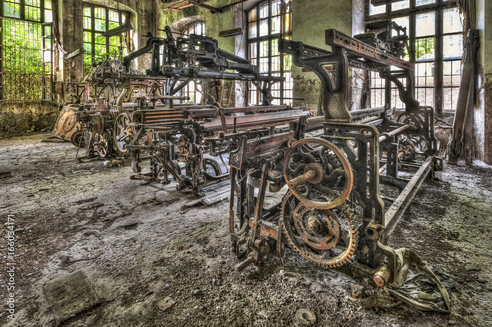 Old weaving looms and spinning machinery at an abandoned factory Stock ...
