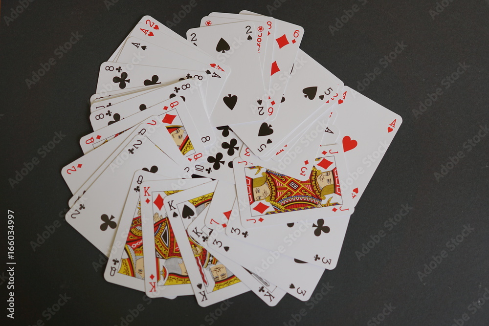 Deck of playing card spread out on a table Stock Photo | Adobe Stock