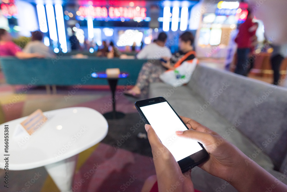 Hands holding blank white screen smart phone in front of the movie ...