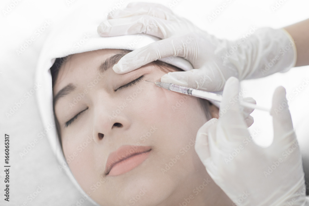 Botox injection under the eyes to reduce wrinkles. Stock Photo | Adobe ...
