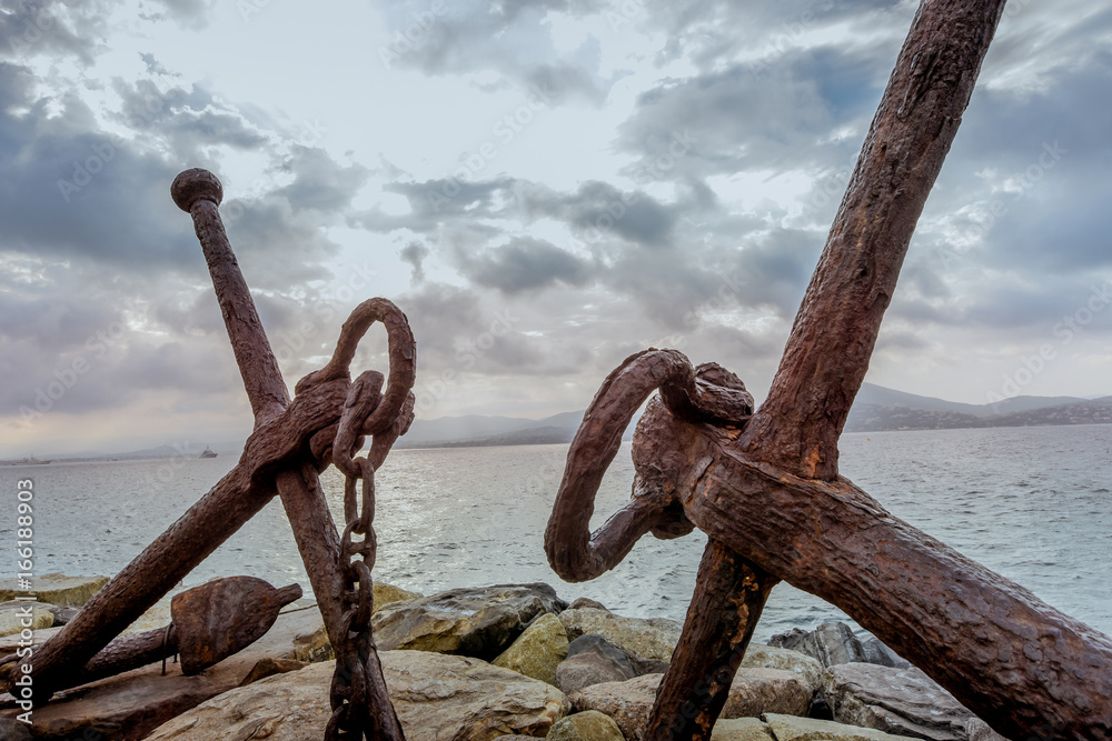 Parts of the iron anchors on the coast. Stock Photo | Adobe Stock
