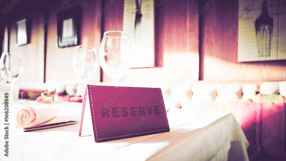 Reservation sign card in the luxury restaurant. Reserved table in at ...