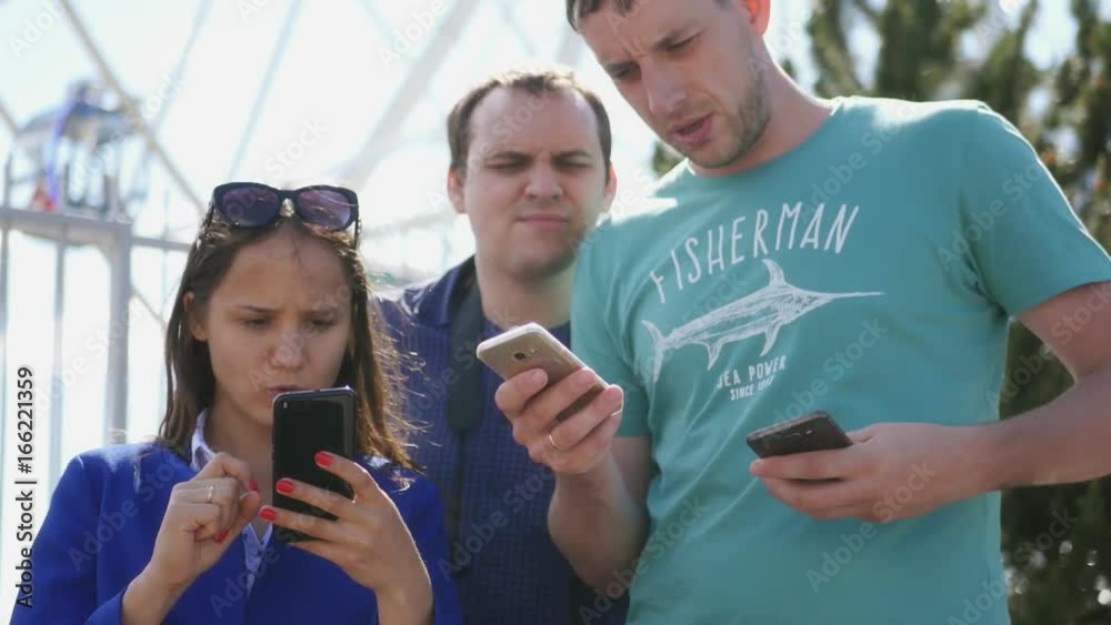 A group of friends the guys and a girl stand with the phones in their ...