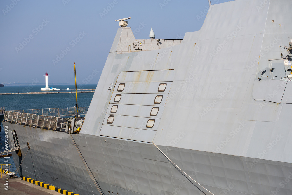 The side of the military ship close-up. Part of the destroyer with ...