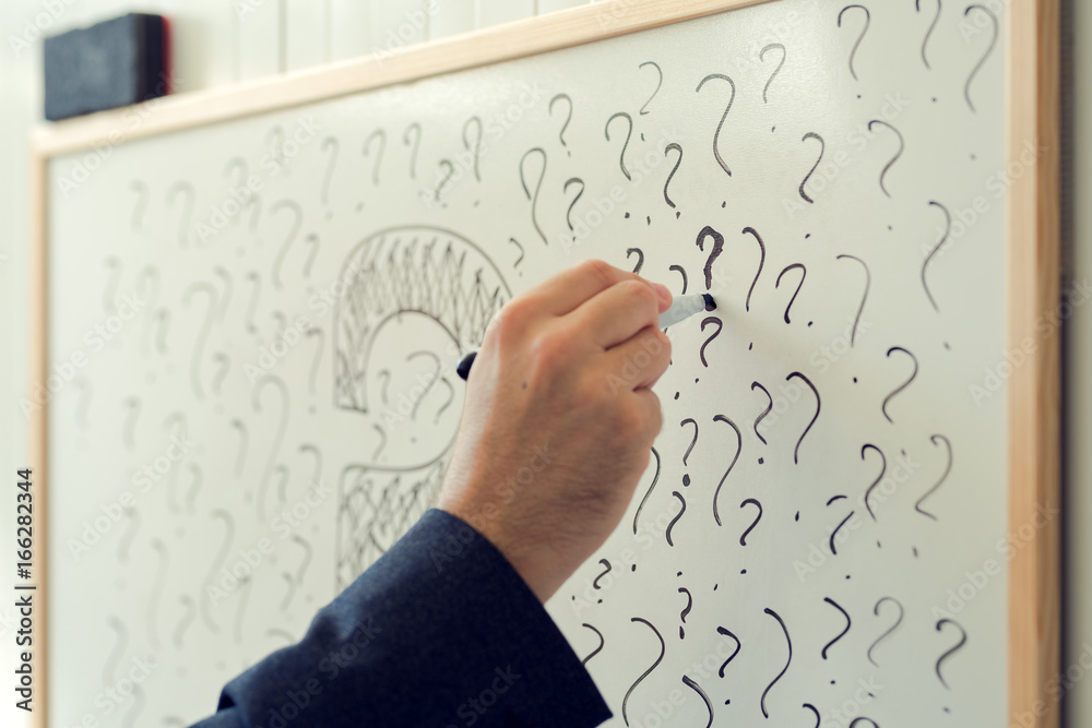 Businessman sketching many question marks on office whiteboard Stock ... Businessman sketching many question marks on office whiteboard Stock ...