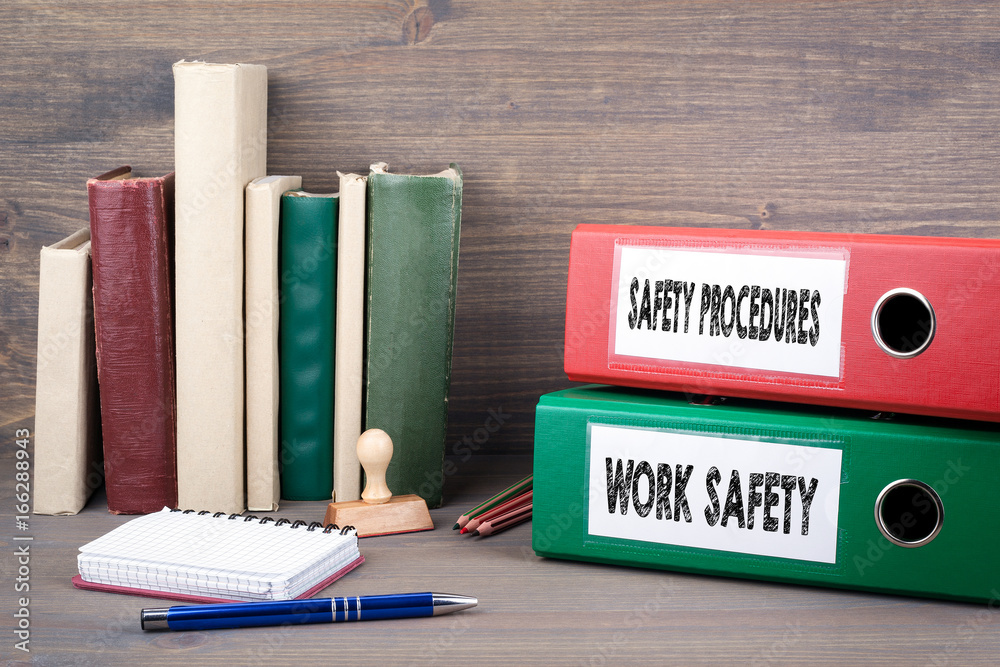 Work Safety and Safety Procedures. Binders on desk in the office ...