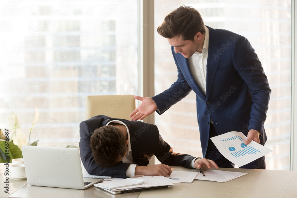 Bad angry boss yelling at male sad depressed employee, lying with face ...