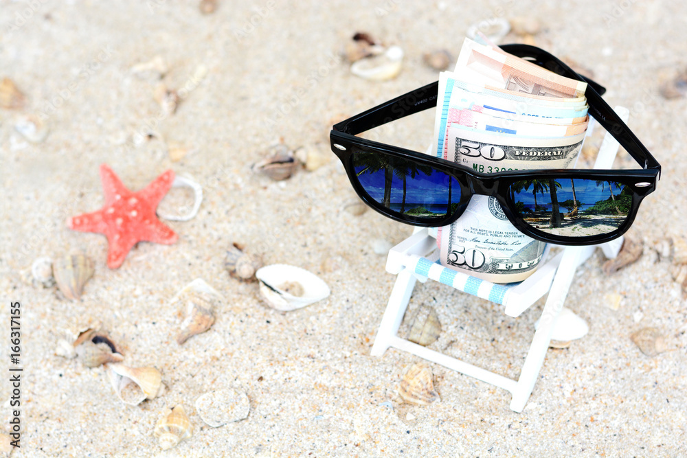 Holiday money concept - Banknotes with sunglasses in a beach chair and ...