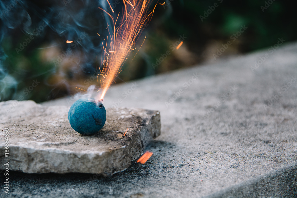 Blue smoke bomb blowing sparks Stock Photo | Adobe Stock
