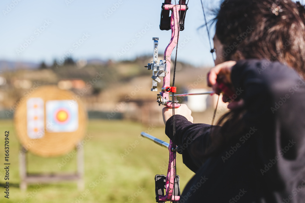 Professional Female Archer Aiming a Target Stock Photo | Adobe Stock