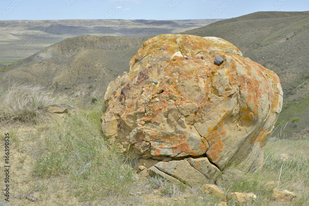 Sand Stone Glacier Erratic Boulder overlooks the valley below. Small ...