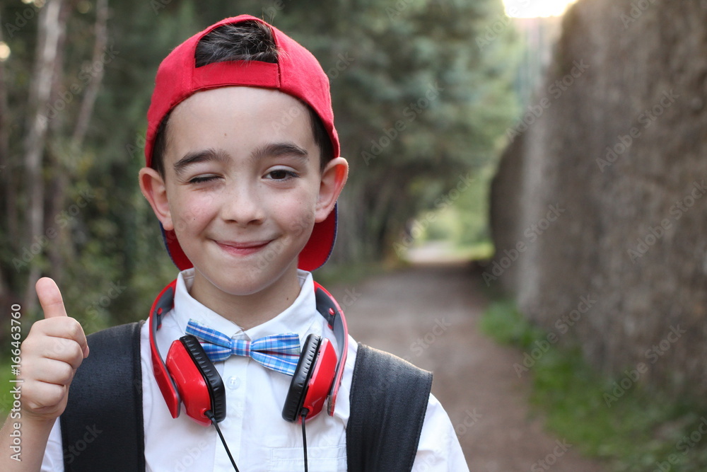 Boy winking and giving a thumbs up on his way to school Stock-Foto ...