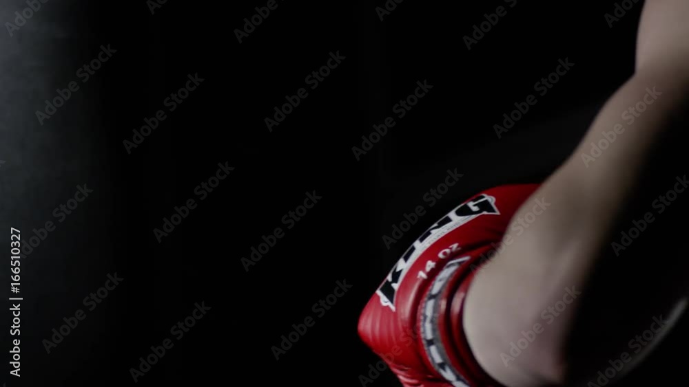 Muscular handsome fighter giving a forceful forward kick during a ...