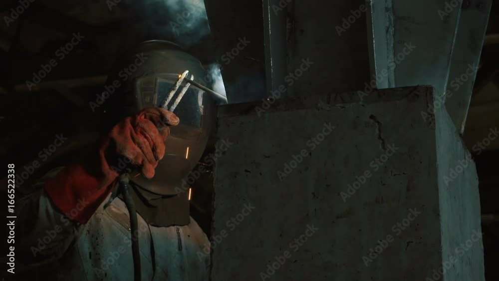 Welder welds the parts of the structure. Manufacture of reinforced ...