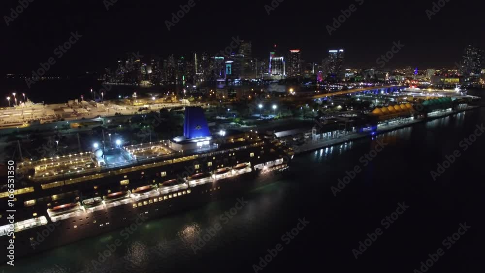 Aerial view of the Port of Miami at night with the city skyline in the ...