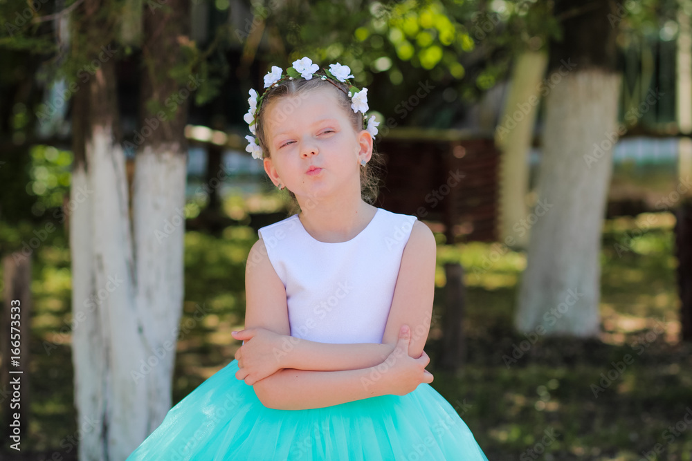 cute small girl flirting and embracing herself,child with a wreath of ...
