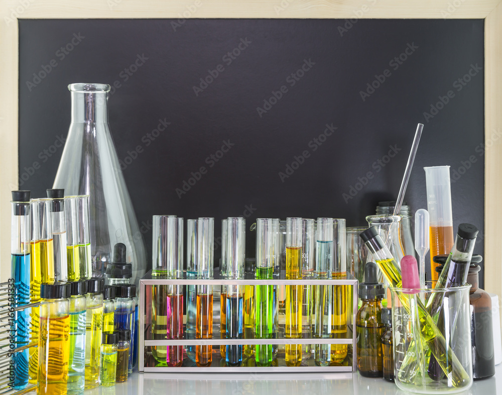Laboratory glass test tubes in test tubes rack and chemical vials with ...