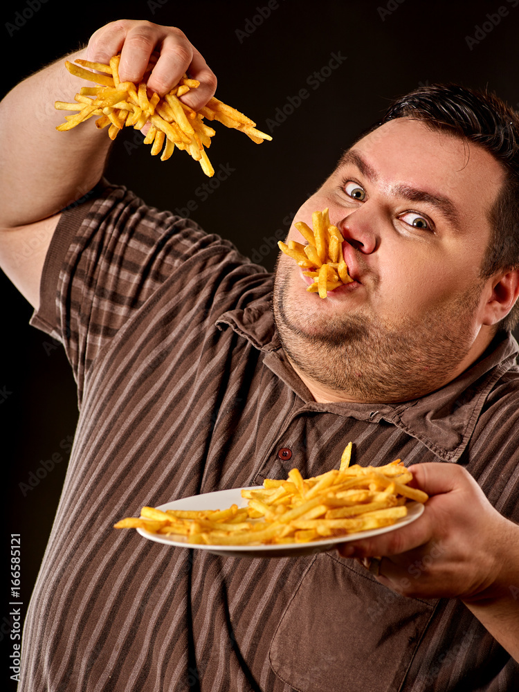 Diet failure of fat man eating french fries fast food. Portrait of ...