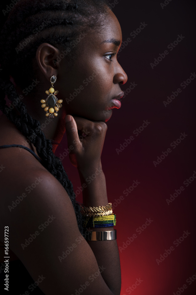 Colorful and creative side view portrait of african woman with dark ...