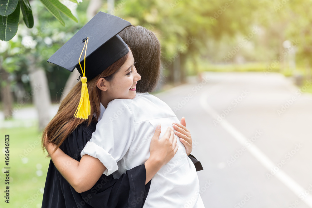 Asian female student and family hug celebrating graduation Stock Photo ...