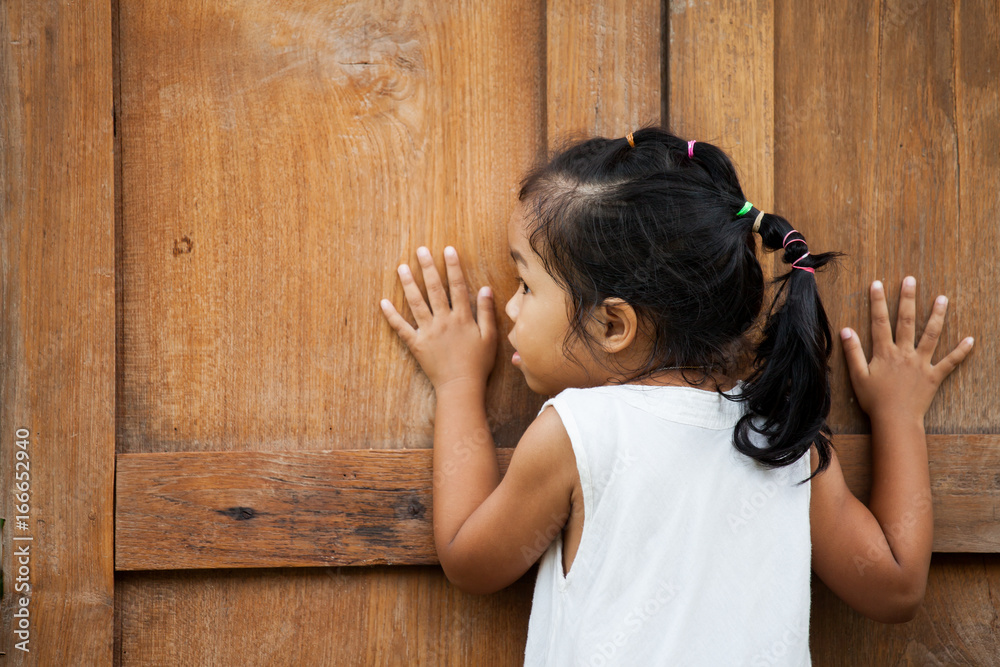 Cute asian child girl listening who will come to her house on the ...