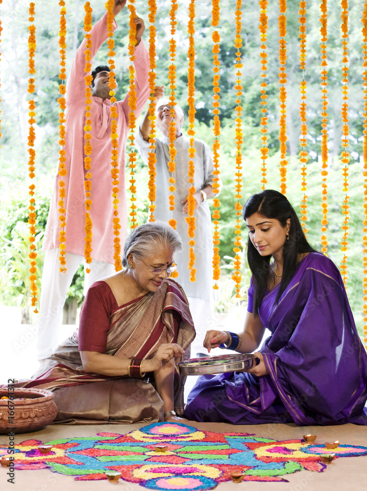Mother and daughter making a rangoli Stock Photo | Adobe Stock