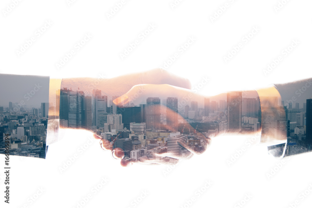 double exposure of shaking hands and urban skyline. abstract mixed ...