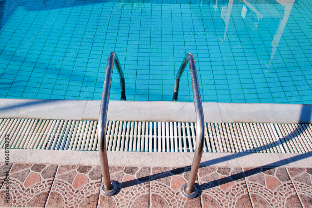 Handrail on the pool. Swimming pool with stair closeup. Pool handrails ...