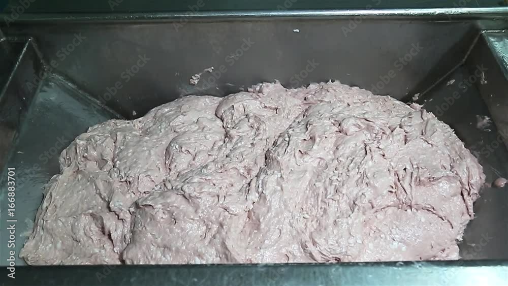 Mixing meat process. Meat Processing Machines Unloads food ingredients ...